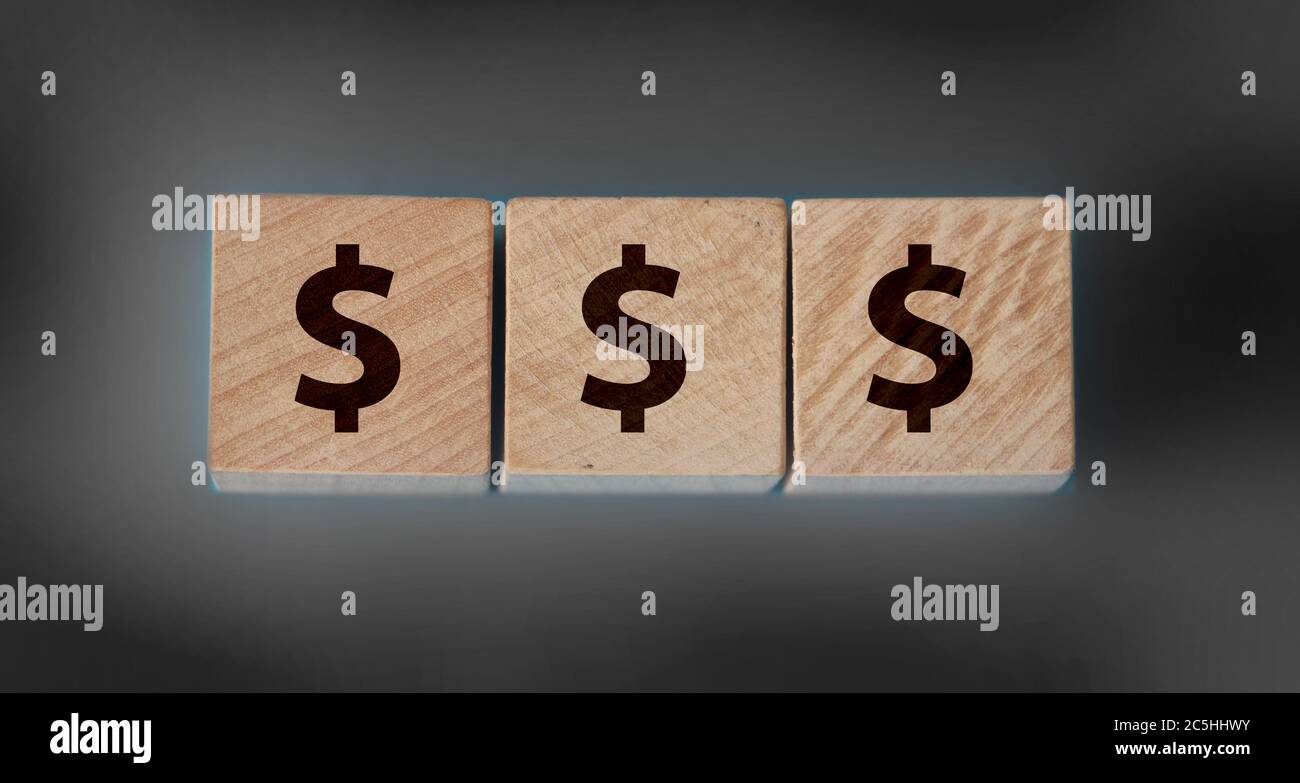 Wooden blocks with dollar signs on black background. Concept of wealth ...