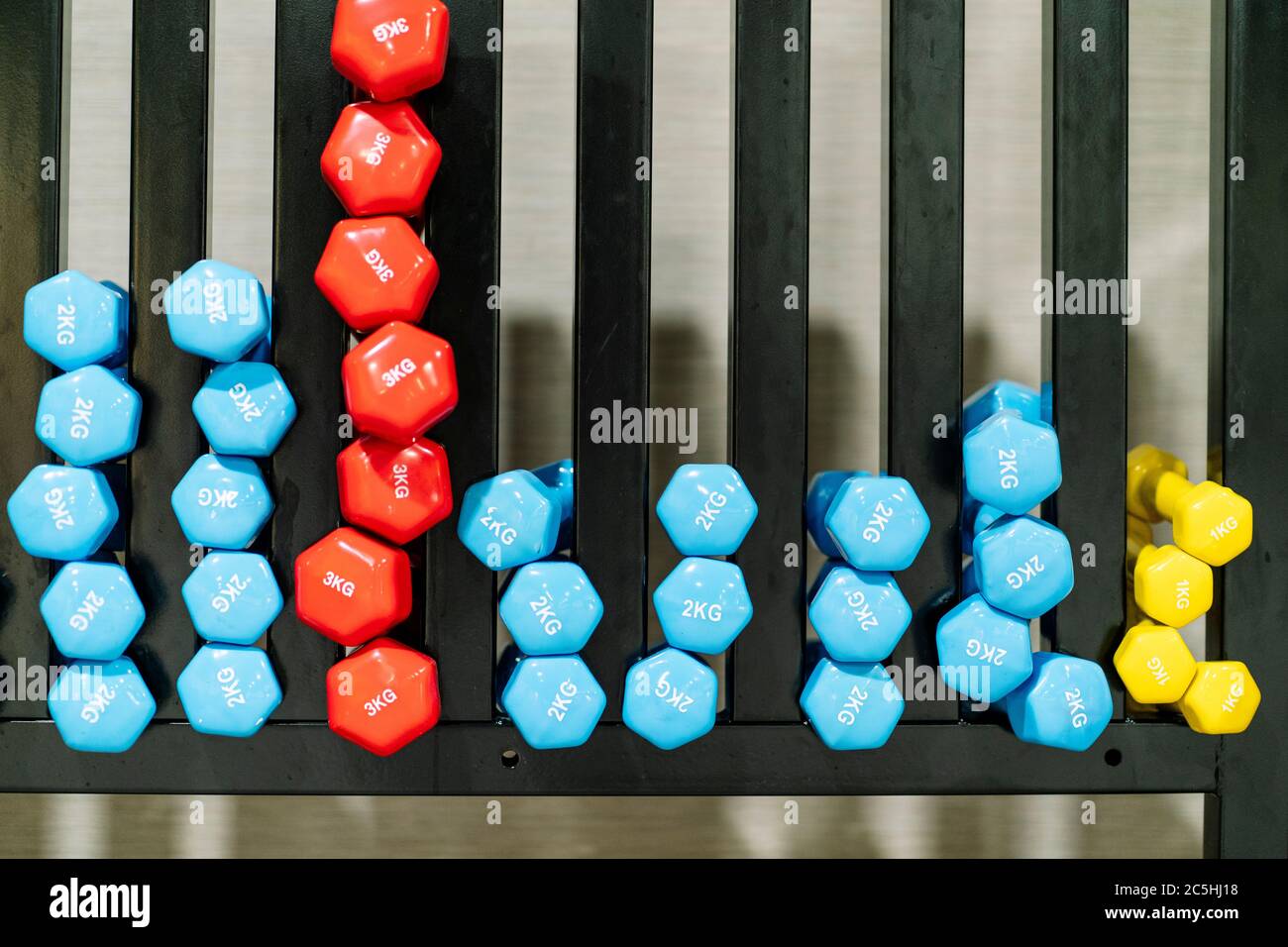 Colored dumbbells placed in the gym Stock Photo - Alamy