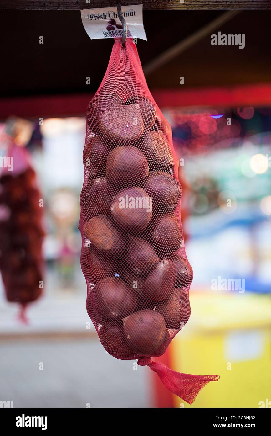 Christmas chestnuts hanging in a net sack Stock Photo - Alamy