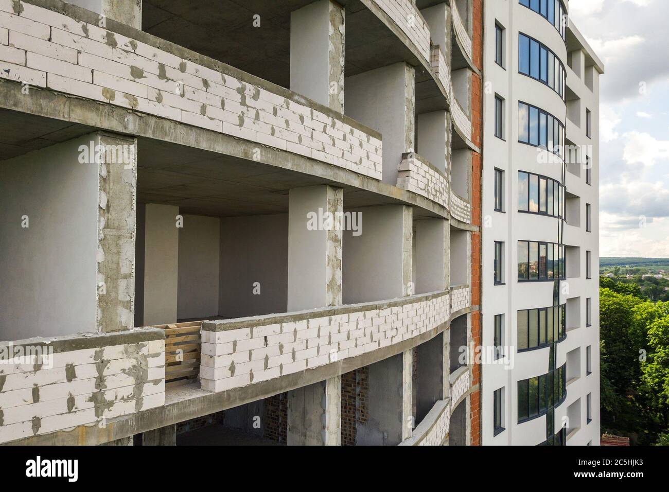 New apartment building facade with many windows and flat rooms under ...