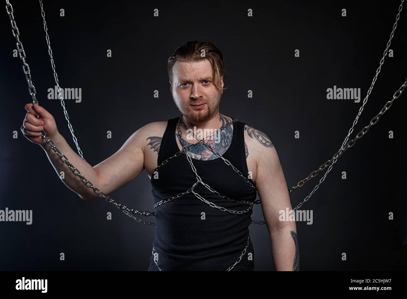 Photo of a tattooed man bound in chains Stock Photo - Alamy