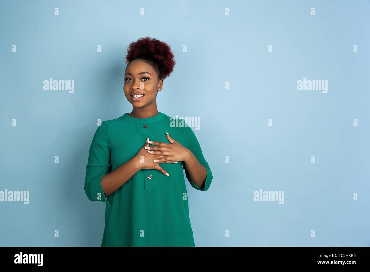 Shy, smiling, embarrassed. African-american young woman's portrait ...