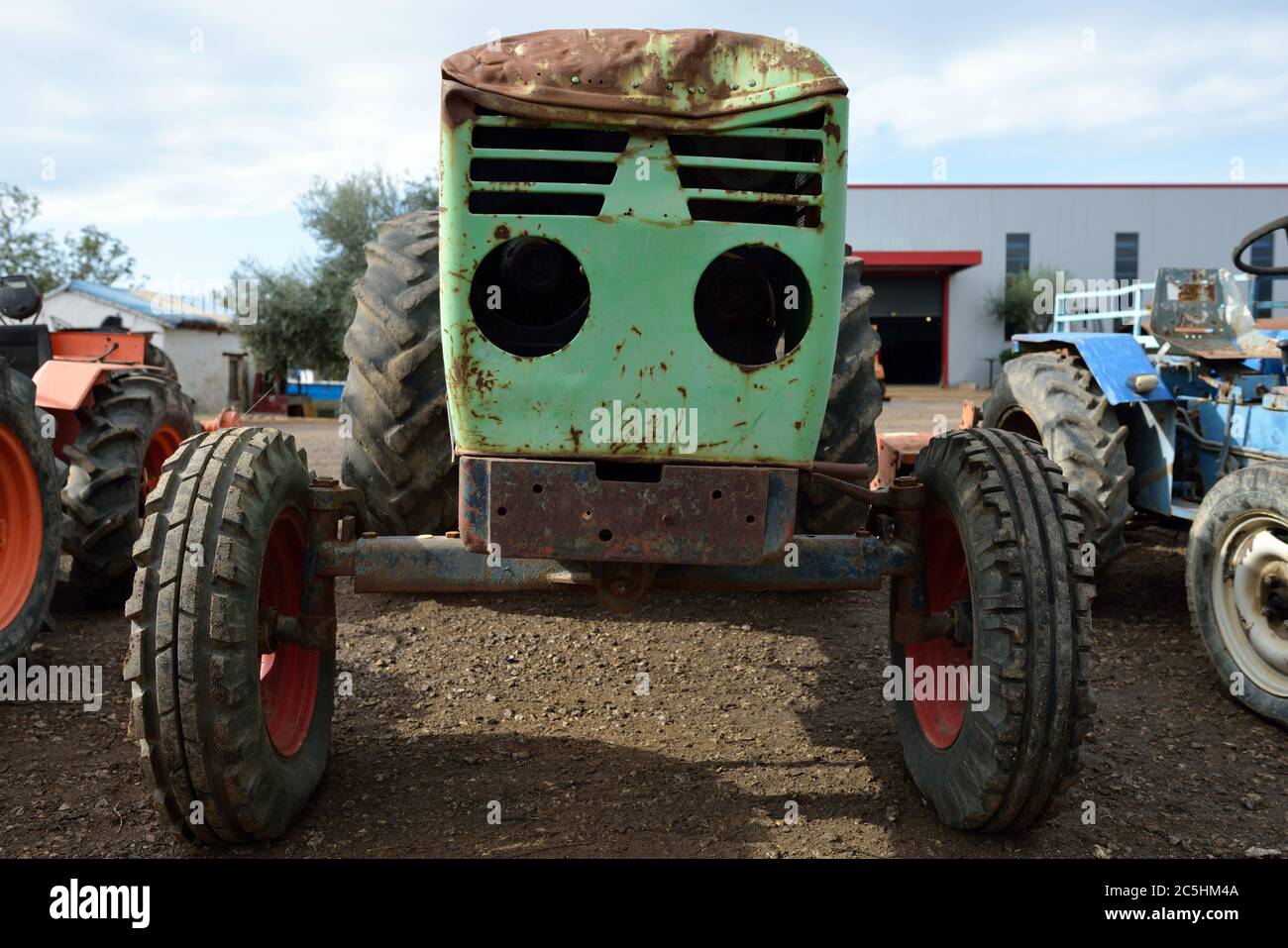 Old wrecked rusty tractor on a junkyard Stock Photo - Alamy