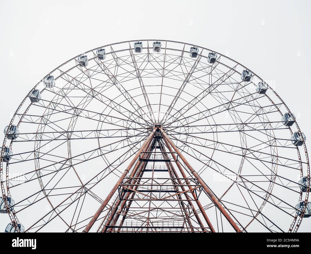 Photo From the bottom up of a tall modern Ferris wheel with enclosed ...