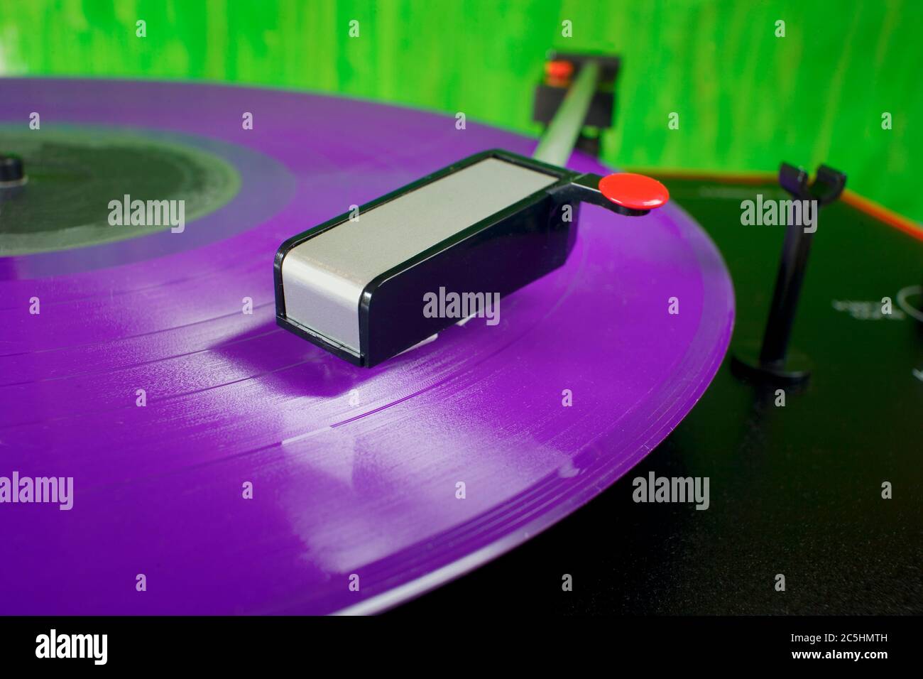 Retro turntable with purple vinyl record, close up, selective focus ...