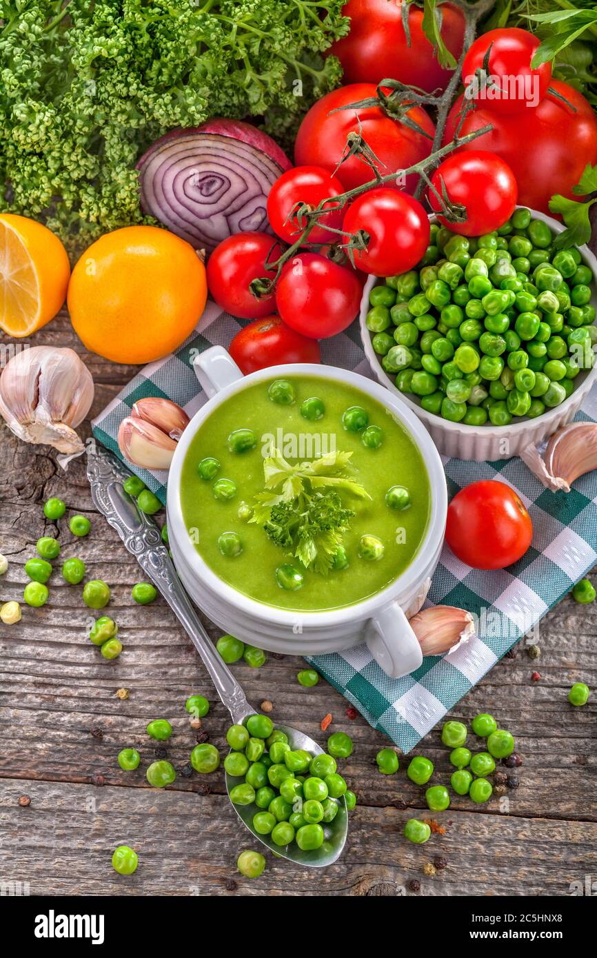 Homemade potage soup made from healthy peas with vegetable decoration ...