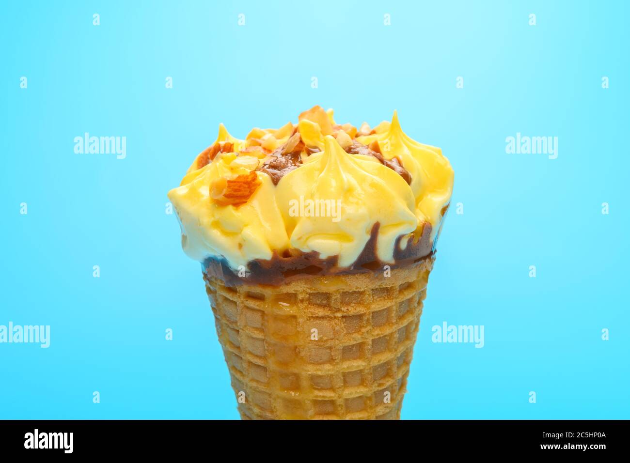 blueberry and cheese flavor ice cream cone starts melting on blue ...