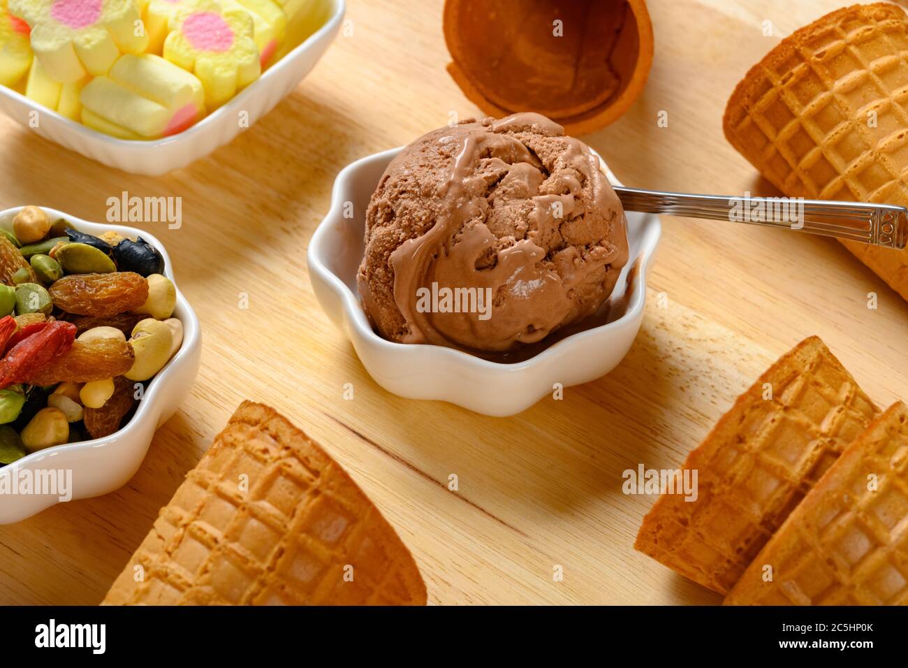 side view chocolate flavor ice cream with marshmallows and various nuts ...