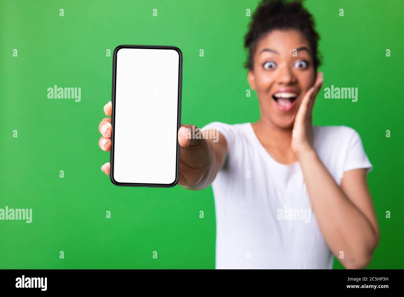 Girl showing white blank cell phone screen at studio Stock Photo - Alamy