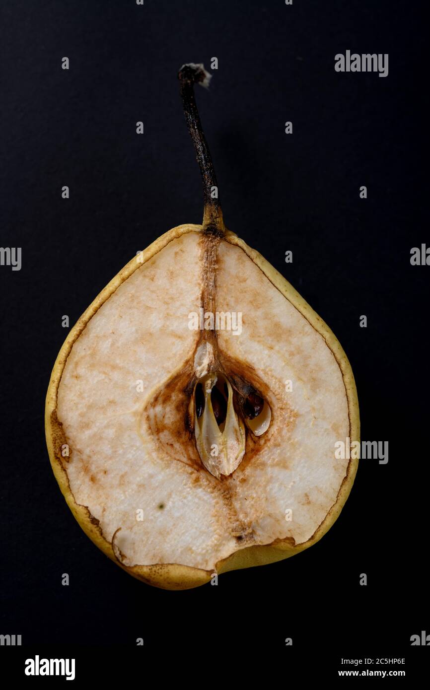 cut out section of an overripe pear on black background Stock Photo - Alamy