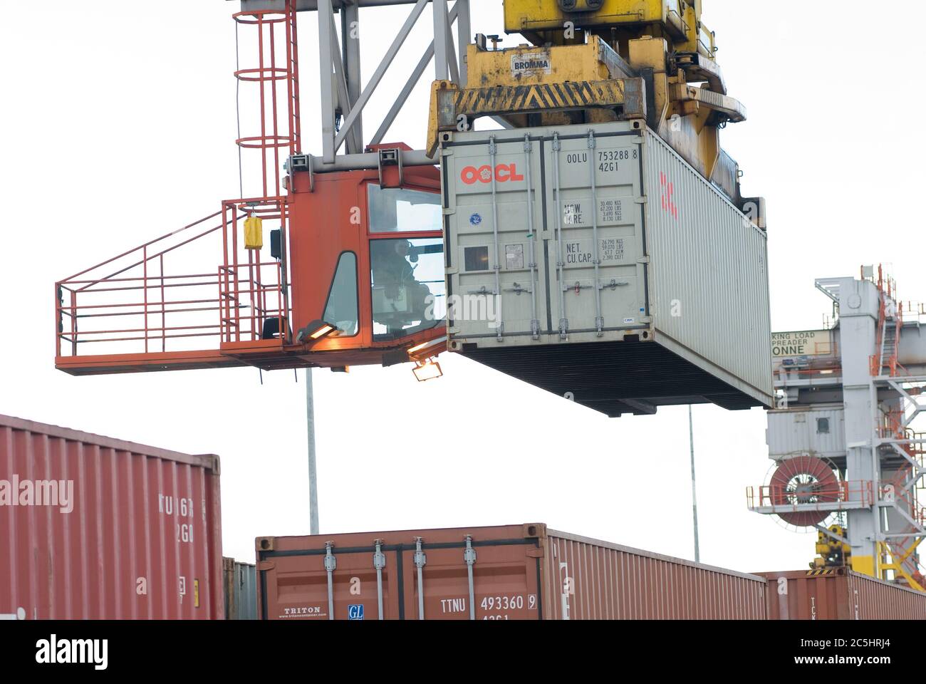 Rail mounted crane being used to load and unload shipping containers ...