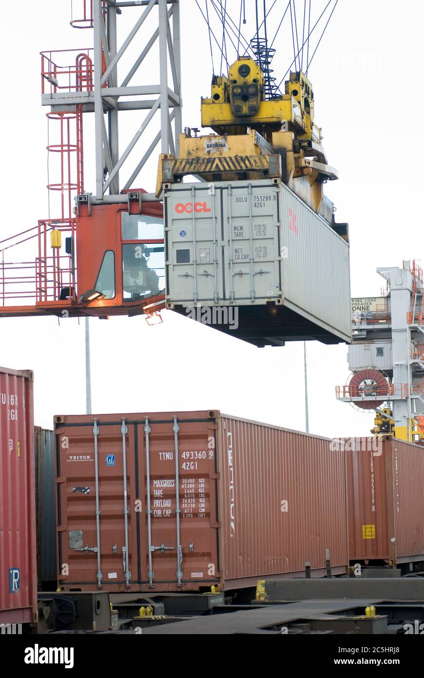 Rail mounted crane being used to load and unload shipping containers ...
