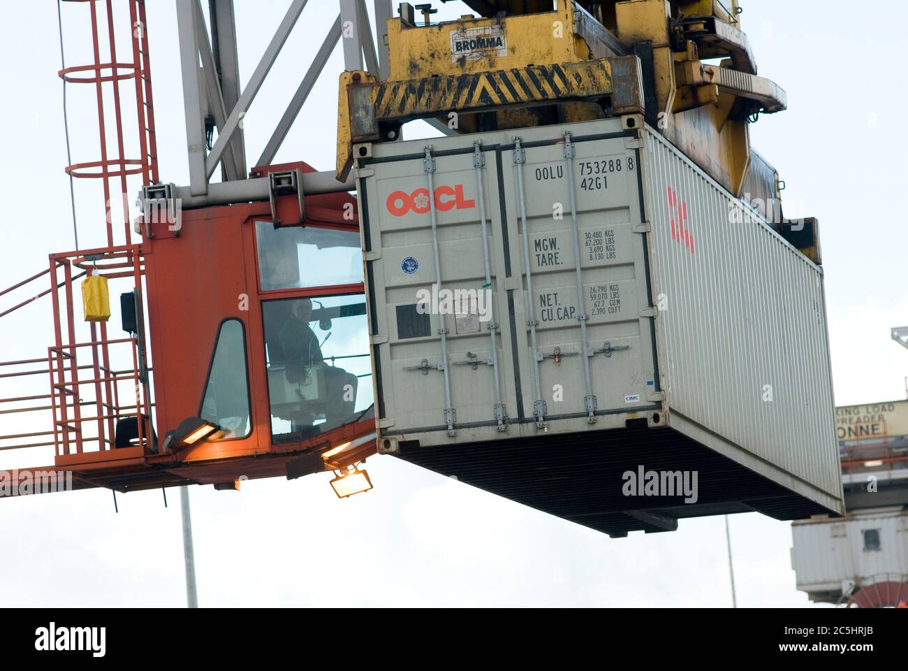 Rail mounted crane being used to load and unload shipping containers ...