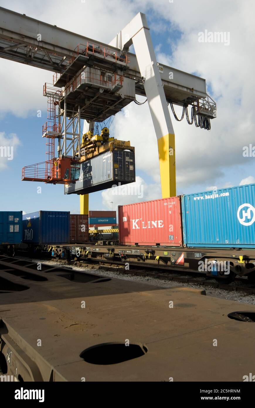 Rail mounted crane being used to load and unload shipping containersat ...