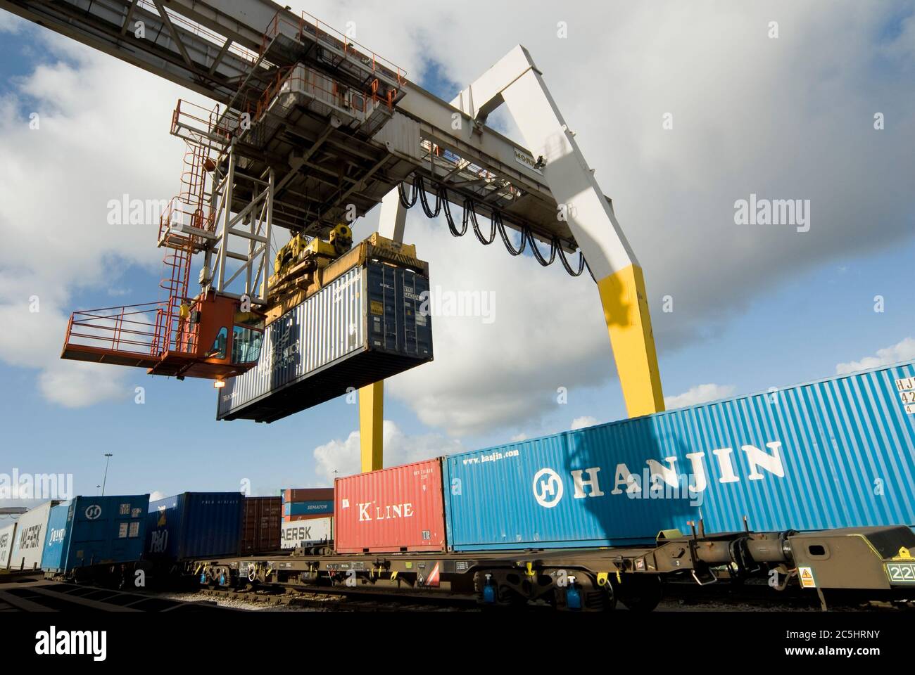 Rail mounted crane being used to load and unload shipping containersat ...