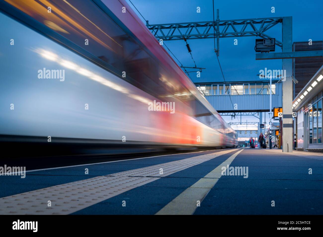 LNER high speed train sppeding through a railway station on the east ...