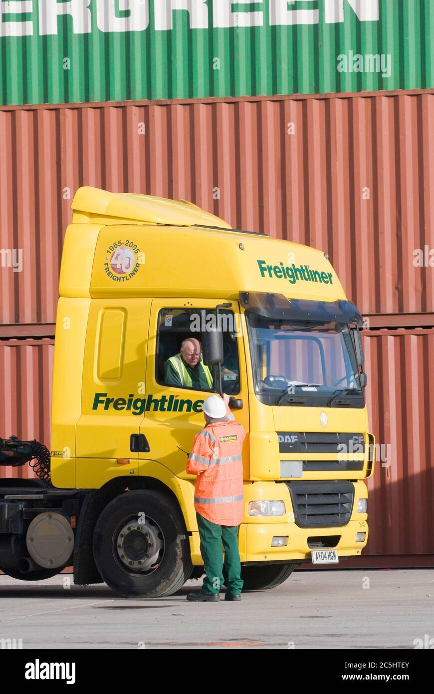 Freightliner lorry driver speaking with a colleague at Manchester ...