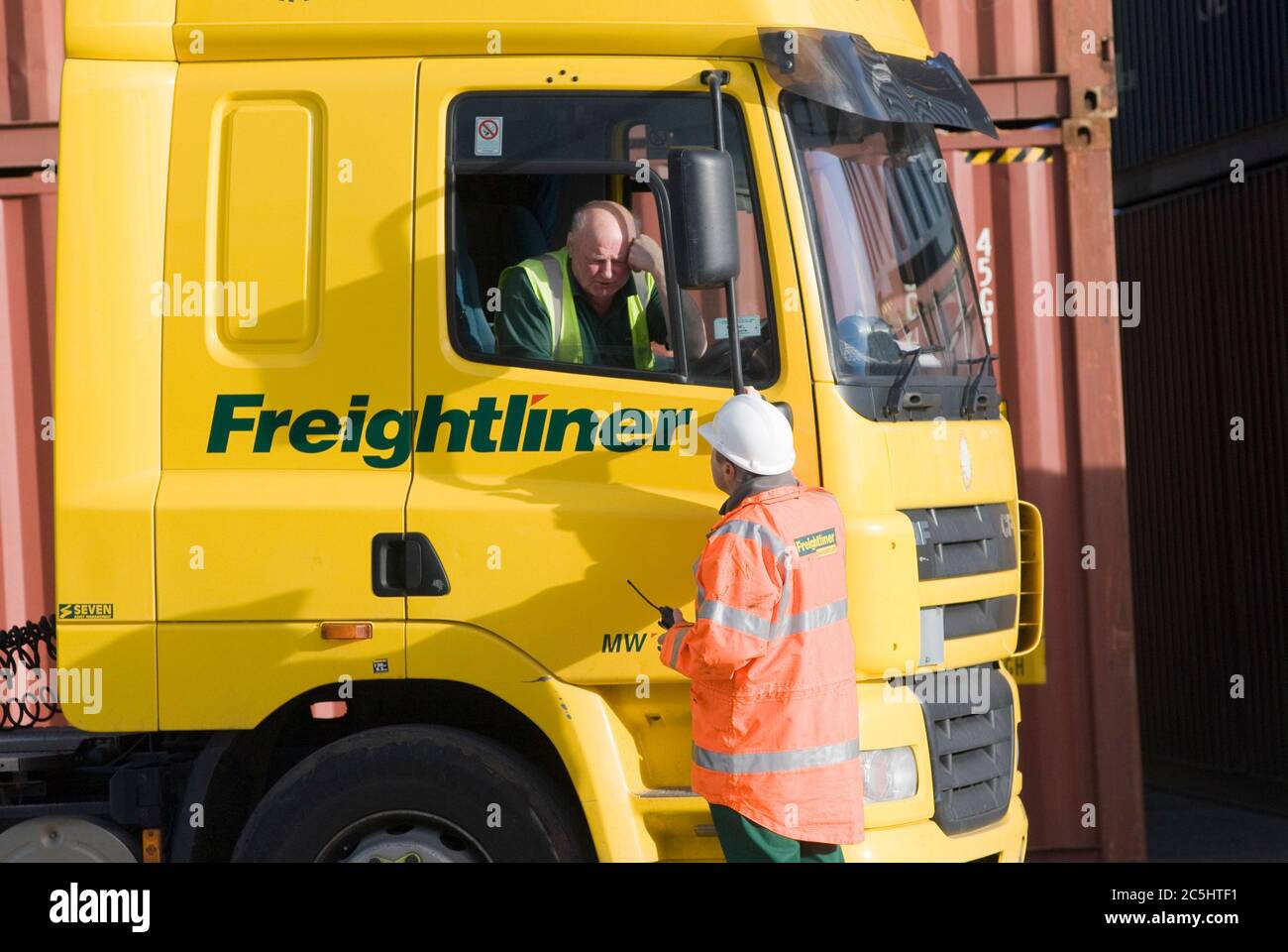 Freightliner lorry driver speaking with a colleague at Manchester ...