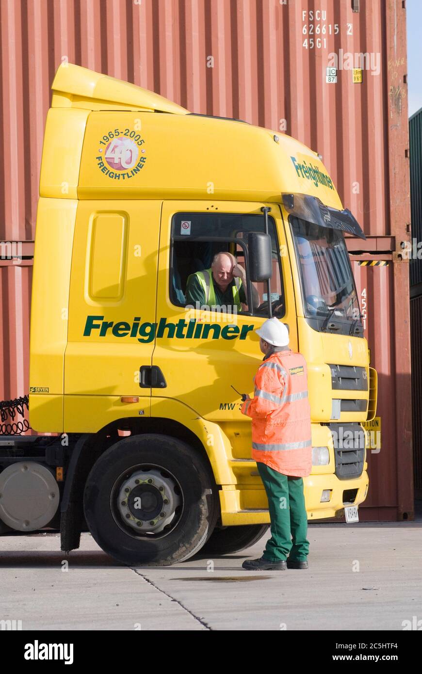 Freightliner lorry driver speaking with a colleague at Manchester ...