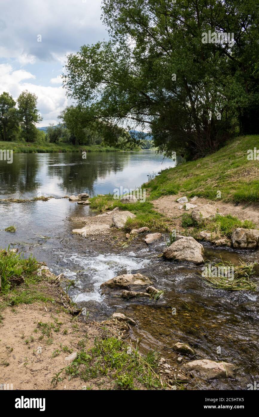 Detail of the water flow in a small river, before it joins the main ...
