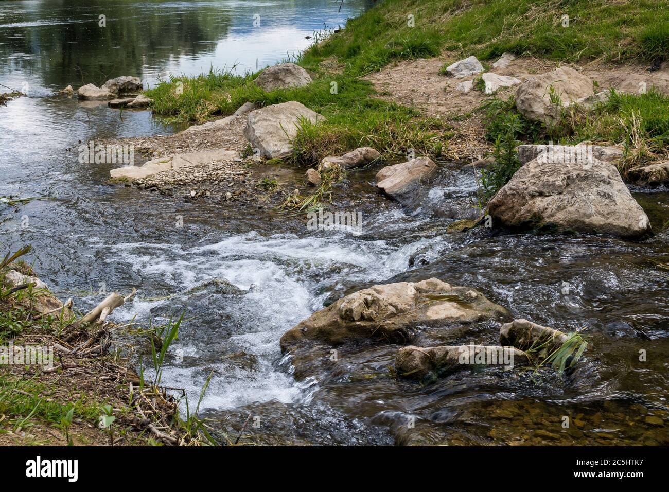 Detail of the water flow in a small river, before it joins the main ...