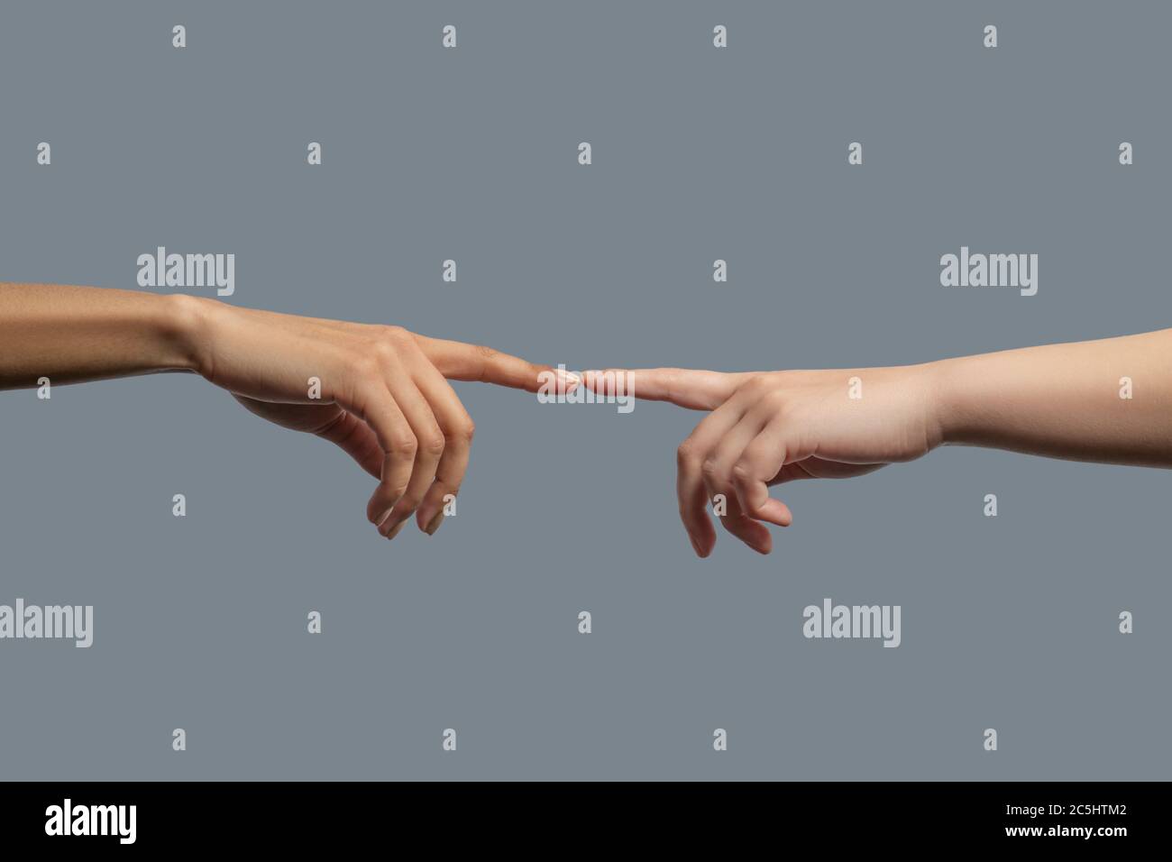 Close-up of people from different races touching two index fingers ...