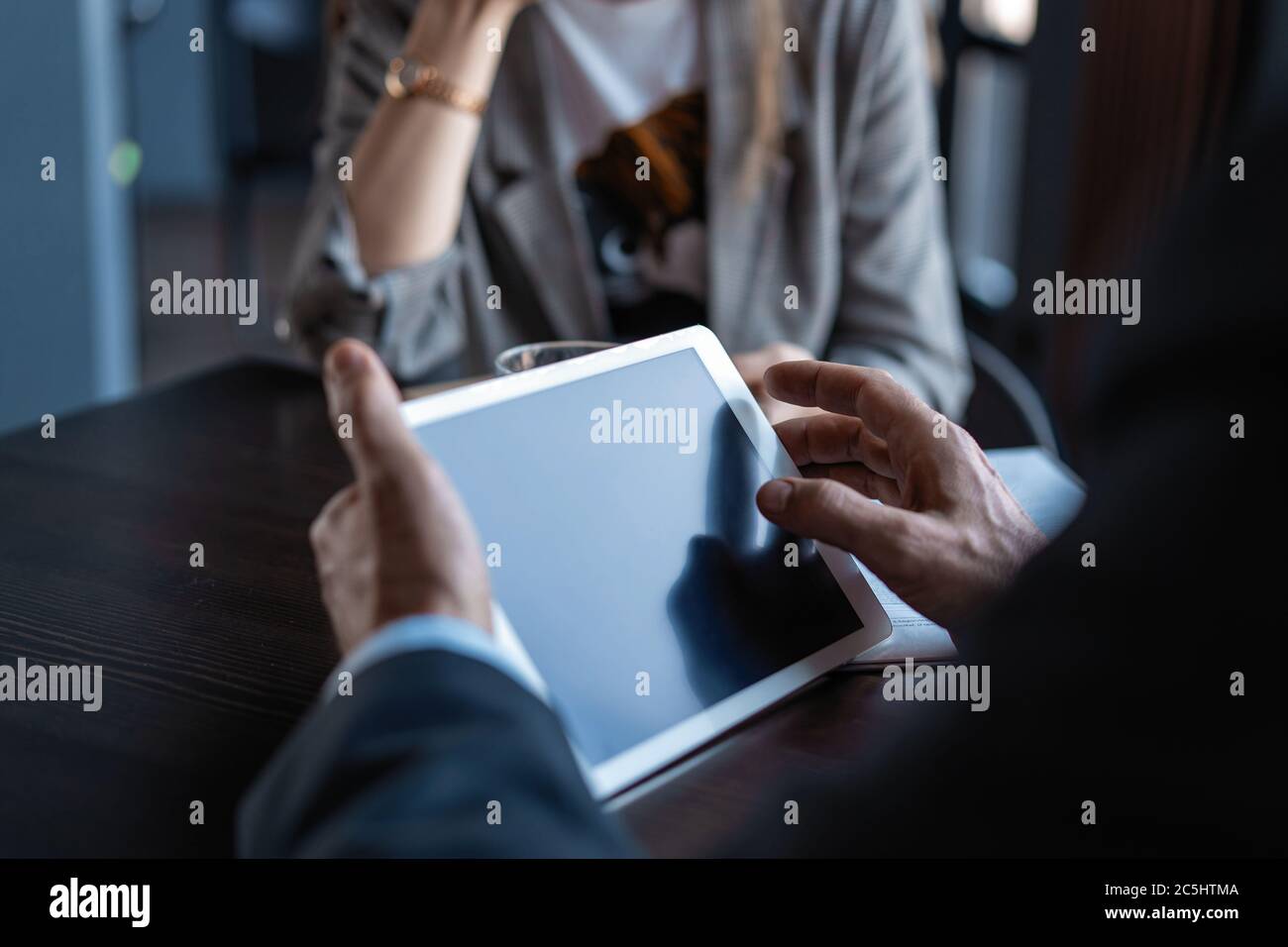 Image of businessman using touchpad at meeting Stock Photo - Alamy