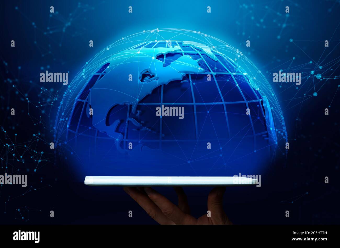 Male hand holding tablet computer with emerging planet surrounded by ...