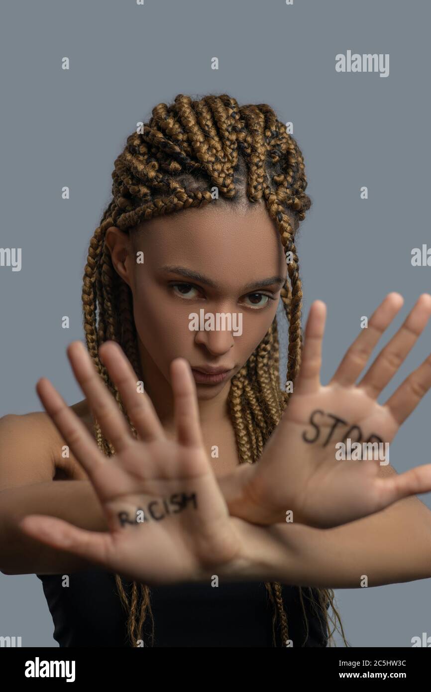 Frustrated young African American woman making cross with arms, showing ...