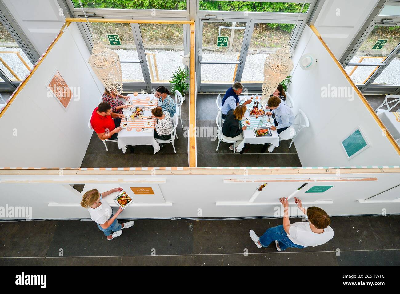 Servers bring food through hatches hi-res stock photography and images ...