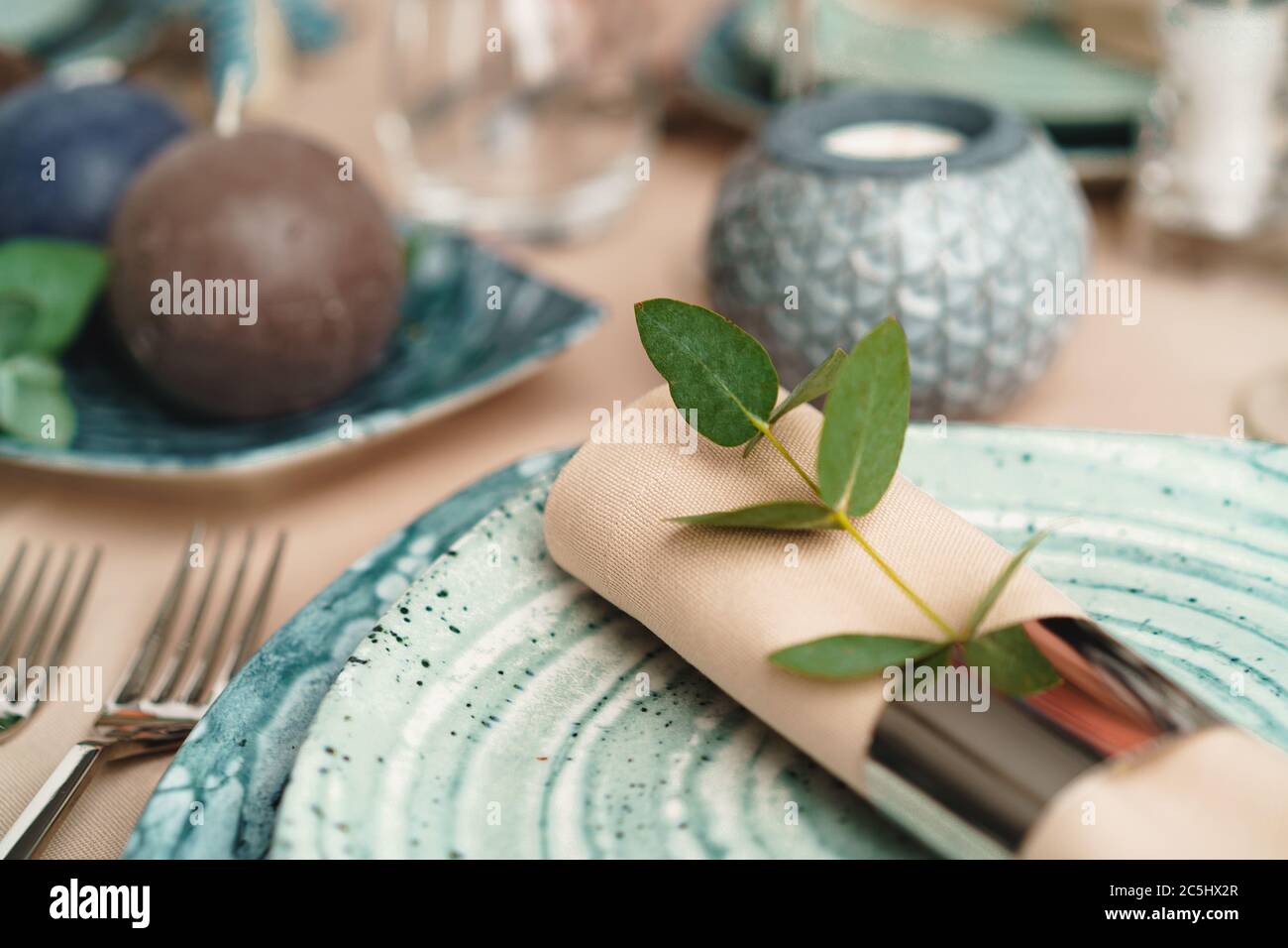 Luxury green table setting decorated with candles Stock Photo - Alamy