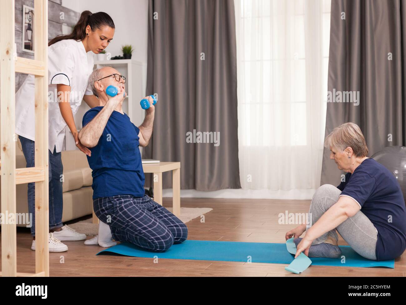 Elderly People Doing Sports With Physiotherapist At Home Home