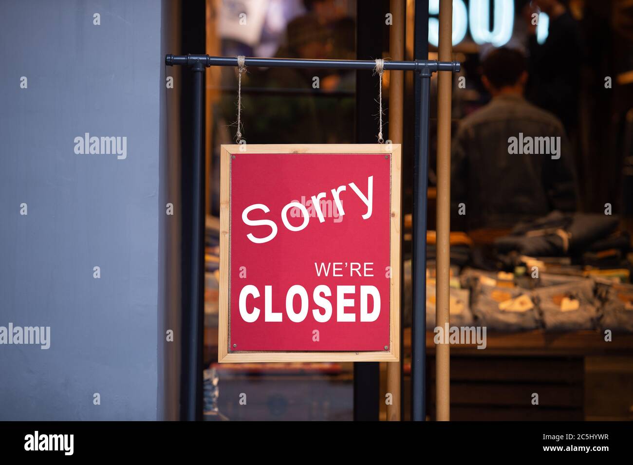 sorry we are closed sign hanging outside a restaurant, store, office or ...