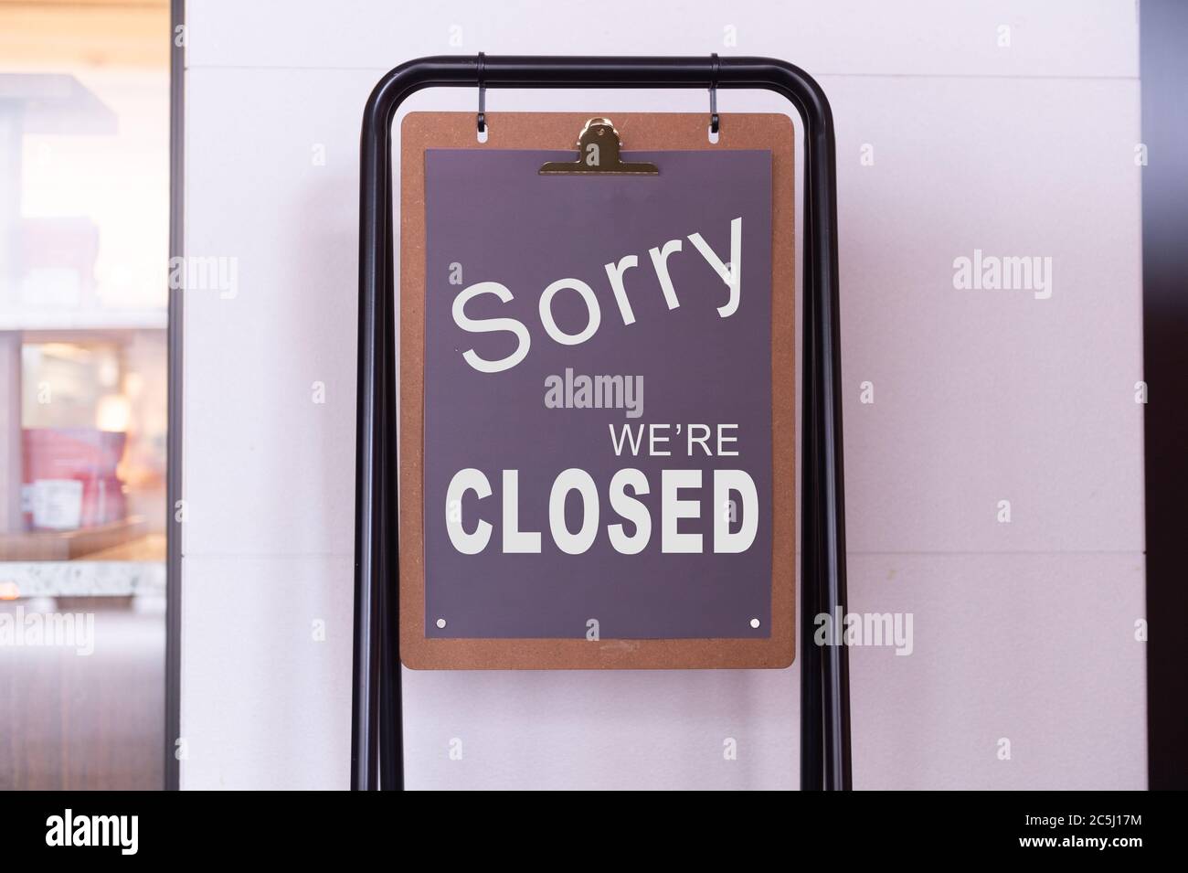 sorry we are closed sign hanging outside a restaurant, store, office or ...