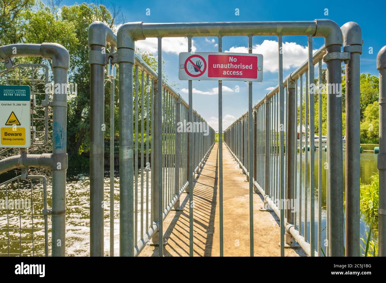 Shallow focus of a No Access Sign seen on a locked metal river crossing ...
