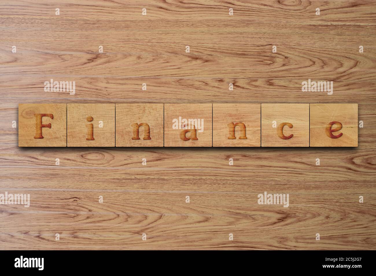 finance word letters on wood block. message text on wooden table for ...