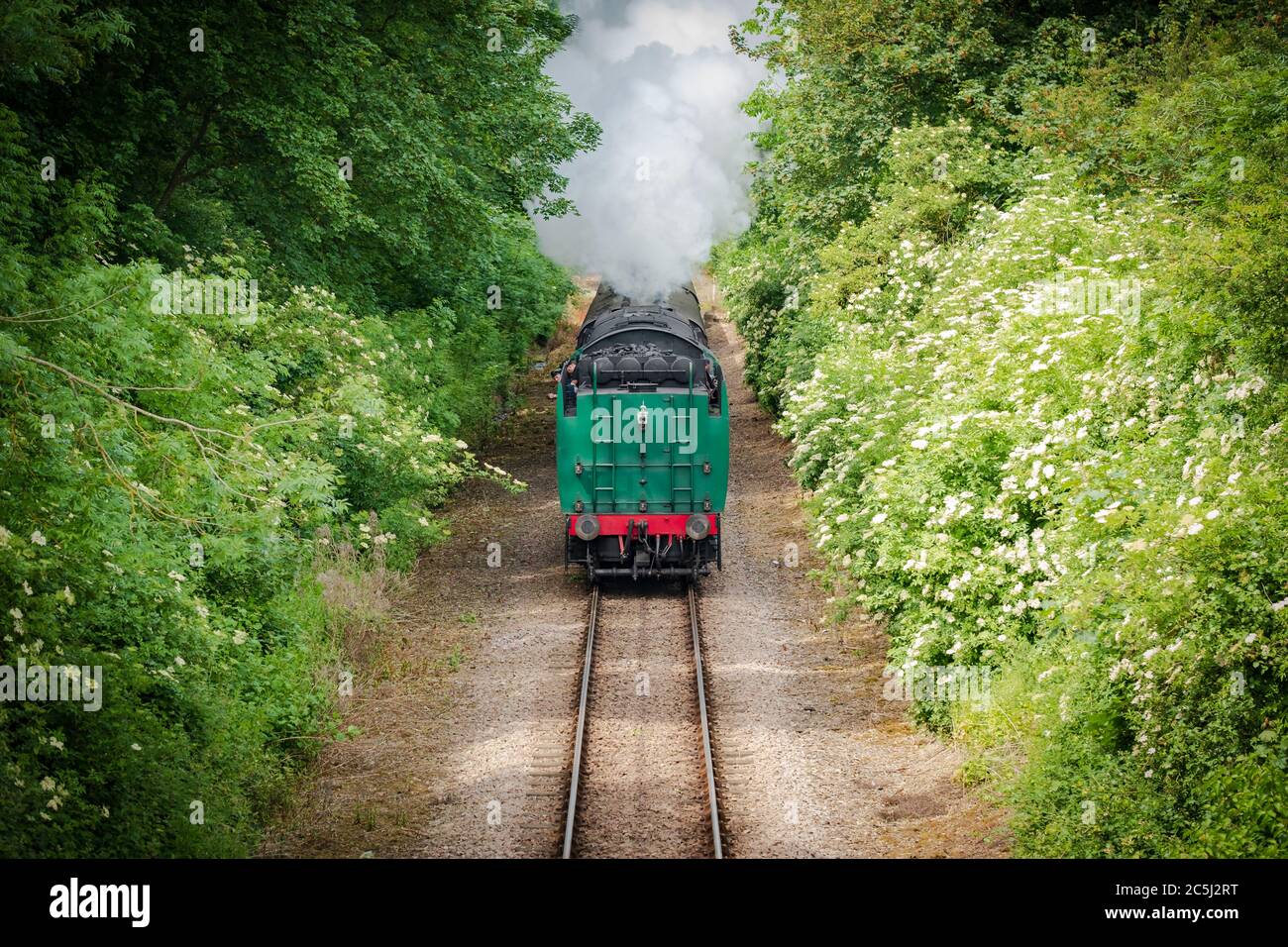 Fast approaching vintage steam locomotive with its coal tender seen ...