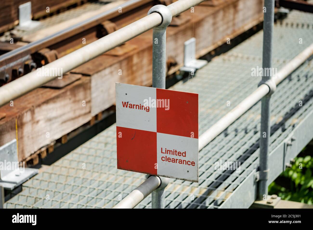 Isolated view of a Limited Clearance sign on a railway bridge. Warning ...