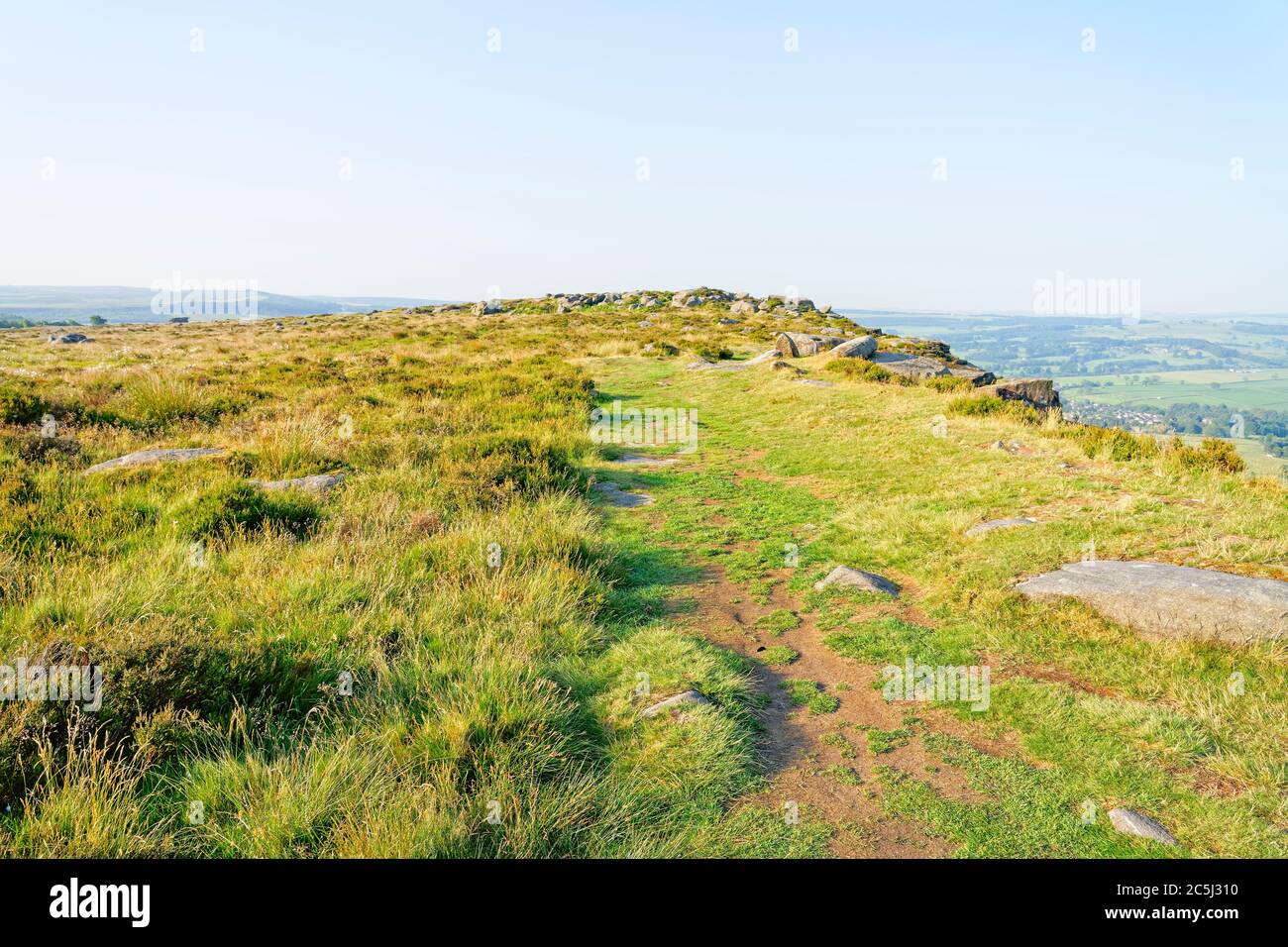 Morning summer sun begins to warm up Baslow Edge in the Derbyshire Peak ...