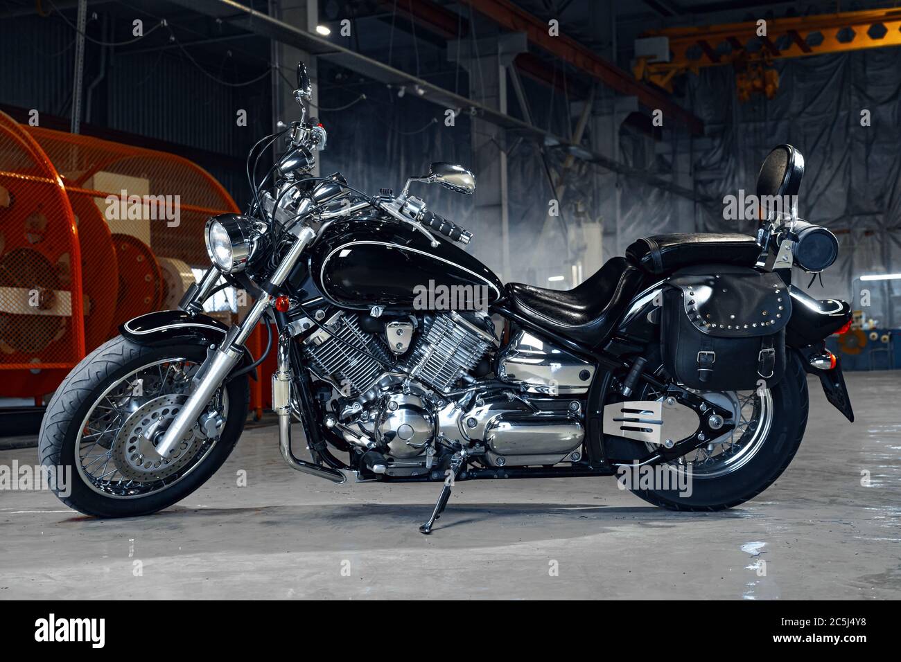 Motorcycle standing in a dark hangar building Stock Photo - Alamy