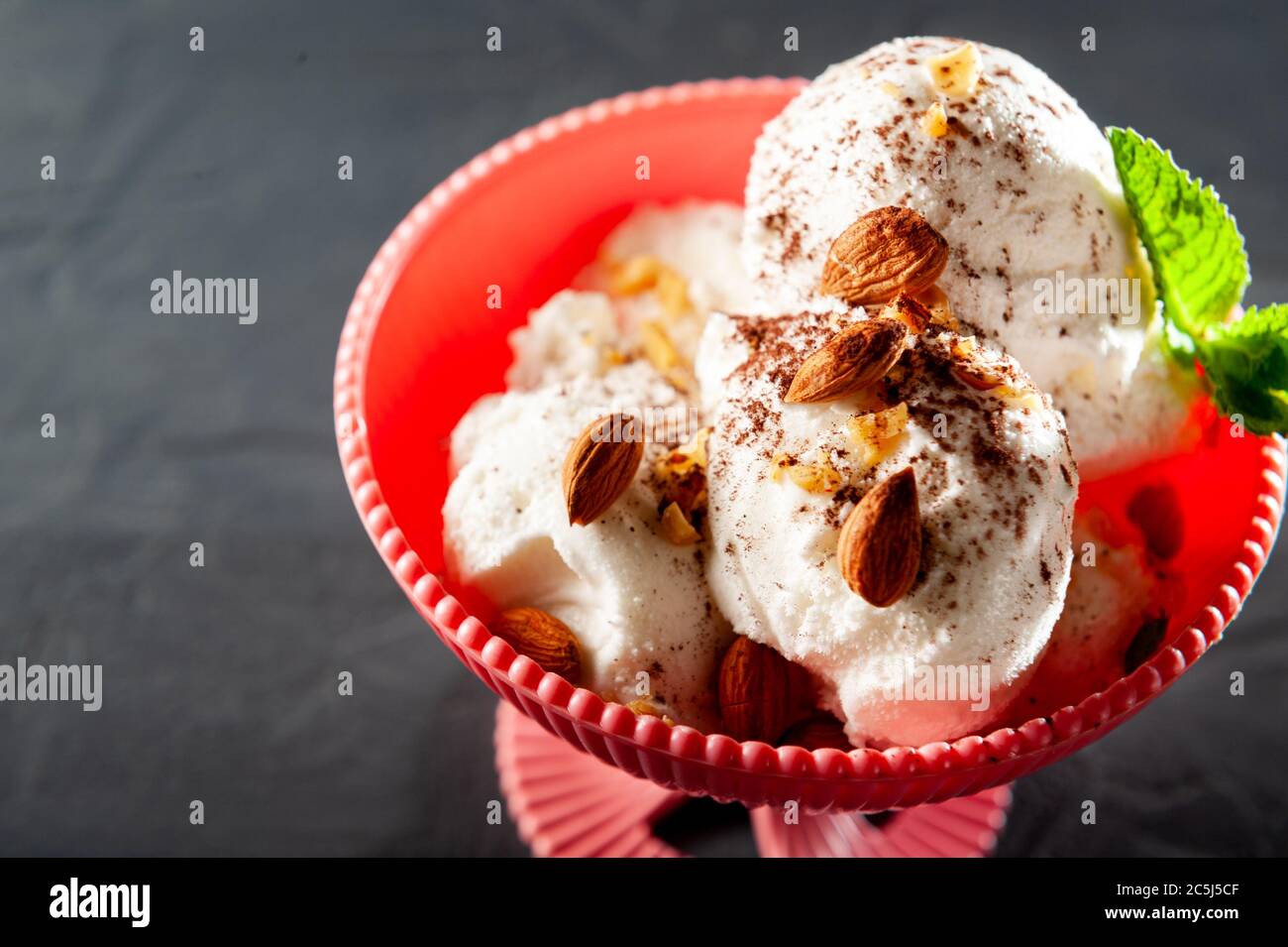 balls of ice cream white filling on a black background with mint and ...