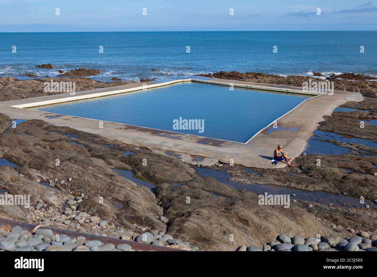 Lady beside the saltwater swimming pool at Westward Ho!, North Devon ...