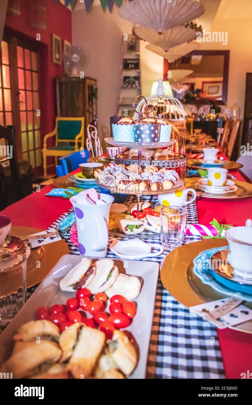 Colorful Tea party with table laid out fancy tea cups and saucers, with ...