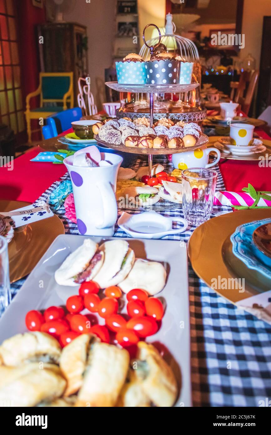 Colorful Tea party with table laid out fancy tea cups and saucers, with ...