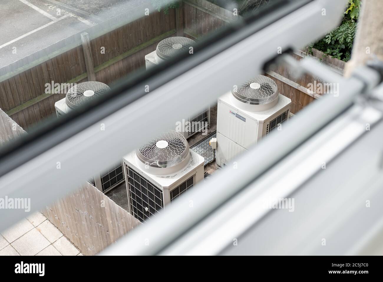Shallow focus of a first storey hotel window looking out to newly ...