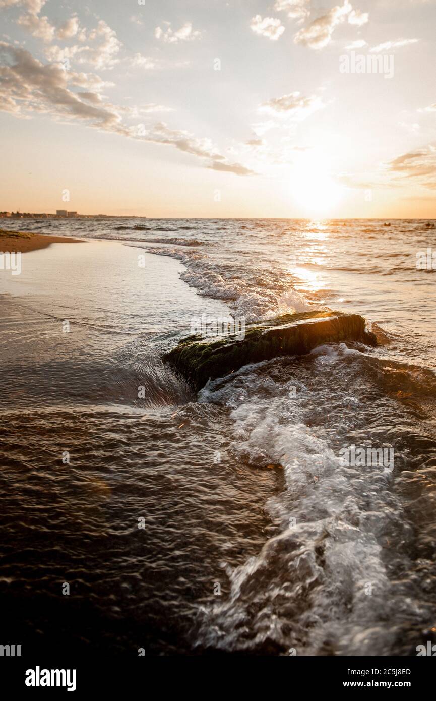 seascape, sea with stones at dawn Stock Photo - Alamy