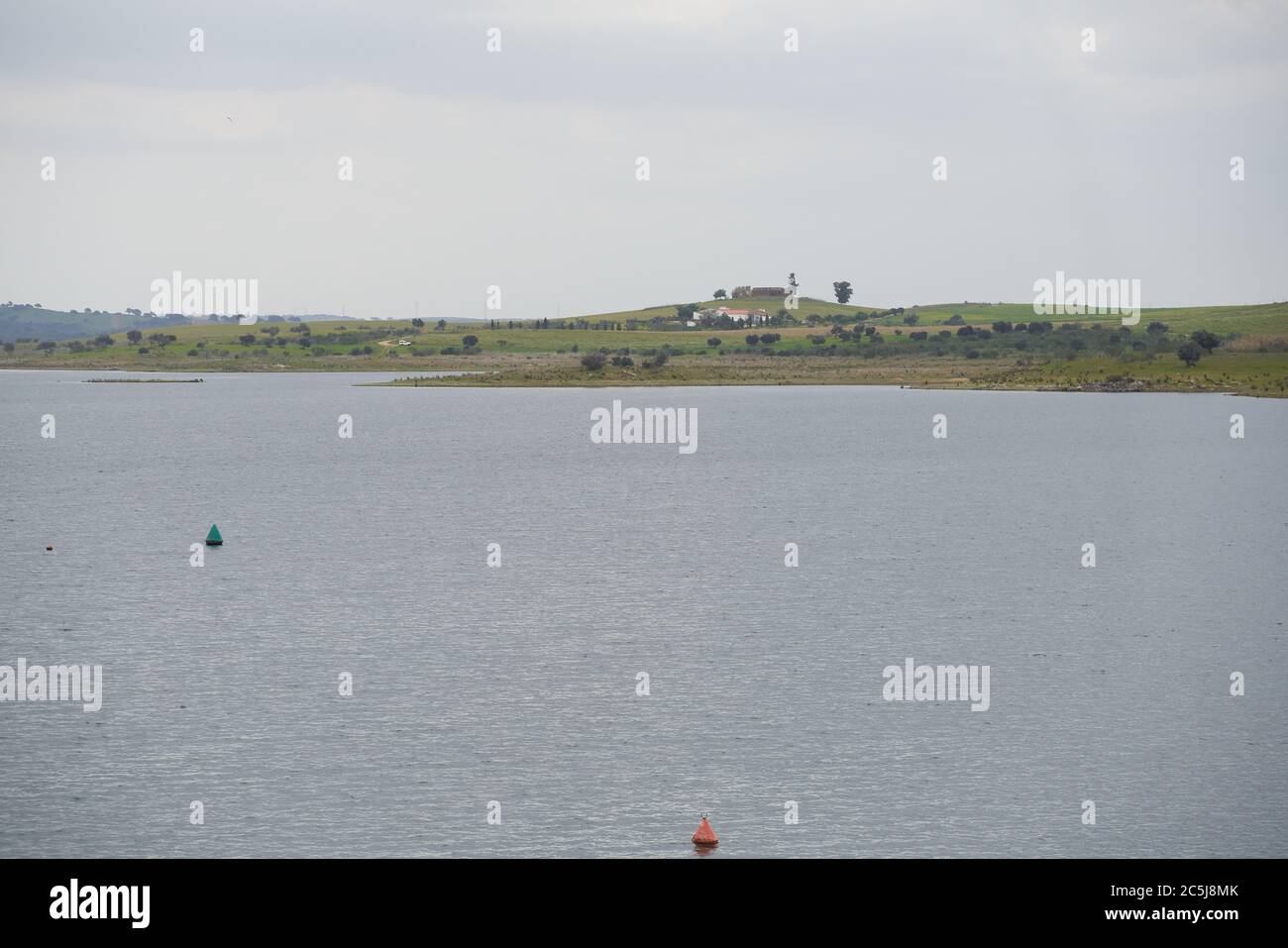 Beautiful house in lake reservoir dam of Alqueva landscape with trees ...