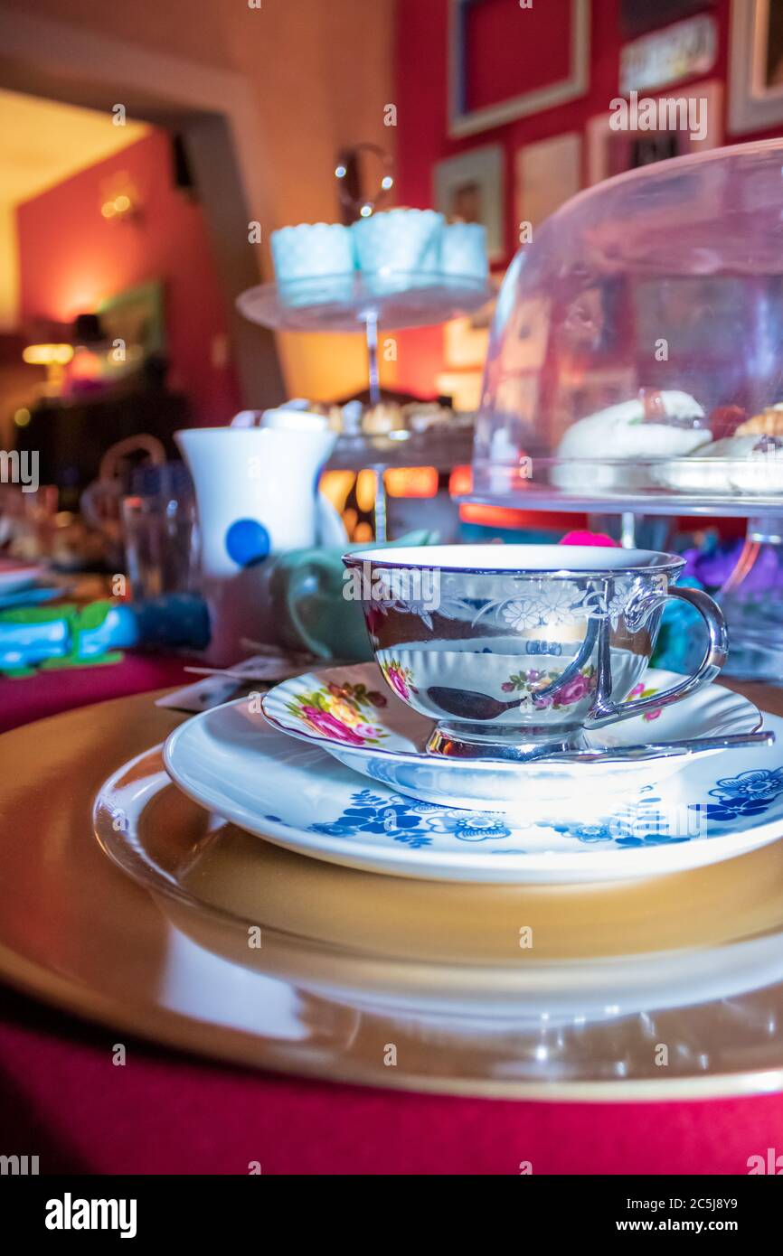 Colorful Tea party with table laid out fancy tea cups and saucers, with ...