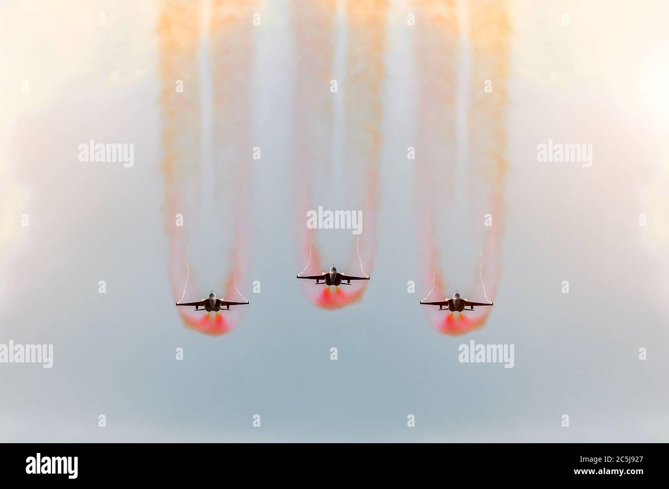 Two fighter jets fly together with red smoke Stock Photo - Alamy