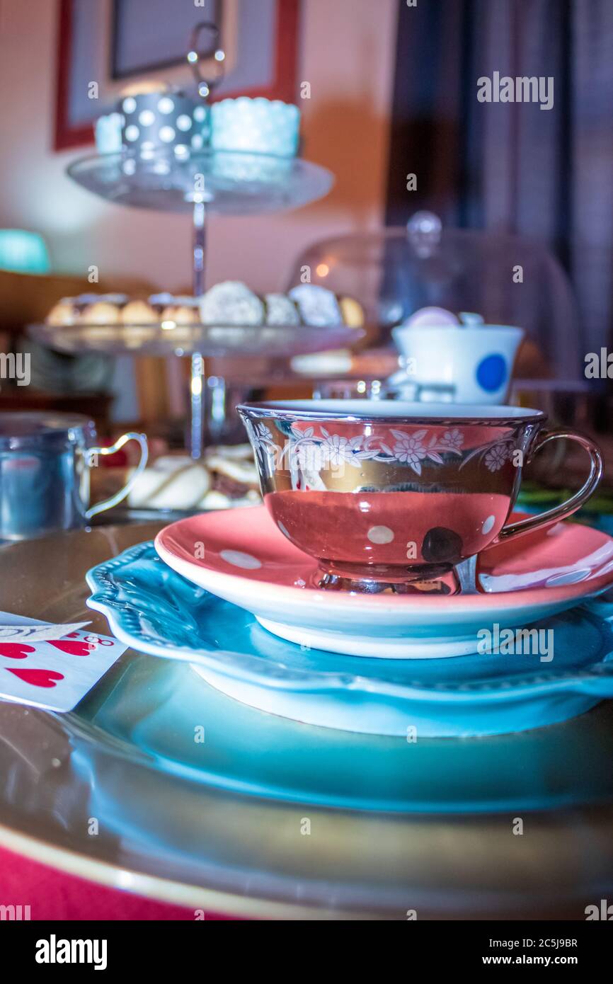 Colorful Tea party with table laid out fancy tea cups and saucers, with ...